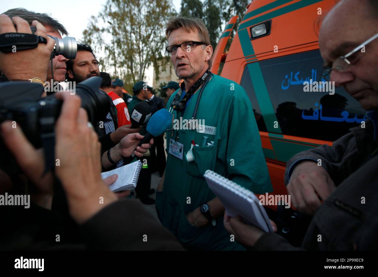 Norwegian doctor Mads Gilbert, center talks to reporters after arriving ...