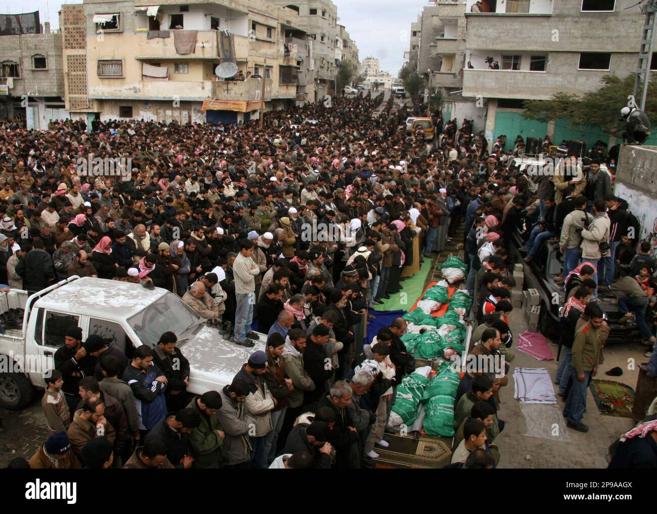 Palestinians pray over bodies during the funeral of Hamas leader Nizar ...