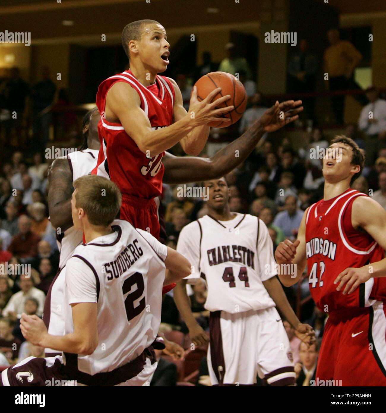 Davidson's Stephen Curry, top, drives for the basket as College of ...