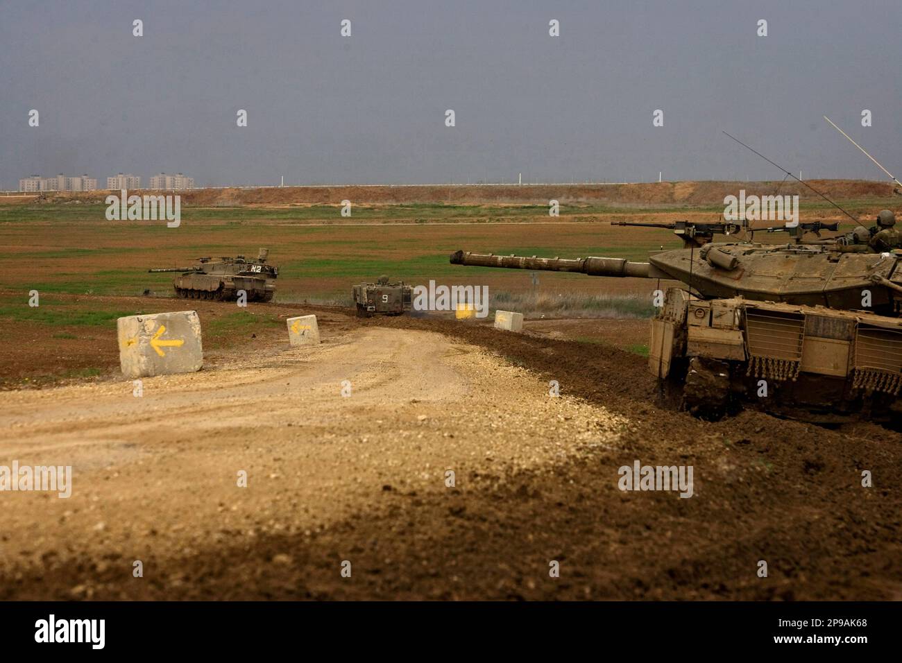 Israeli tanks drive along Israel's border with the Gaza Strip, in ...