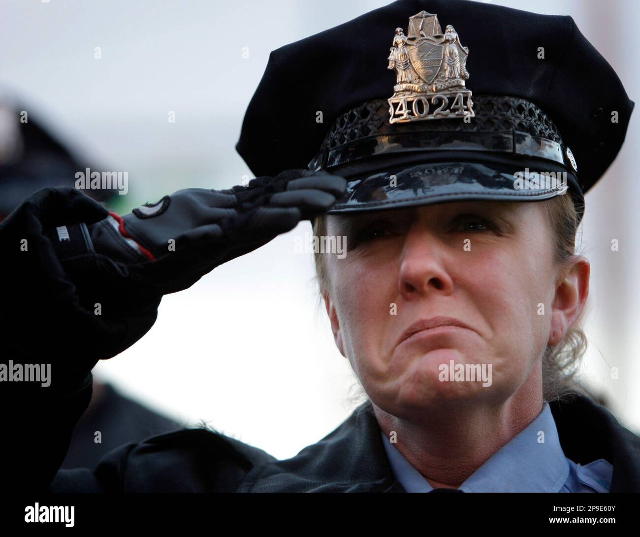 Officer Kathleen DeNofa salutes during vigil for Sgt. Timothy Simpson ...