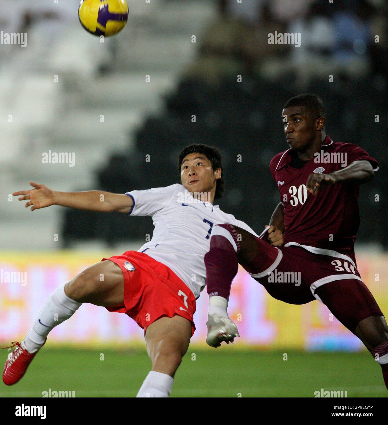 South Korean Player Lee Keun Ho (left) and Qatar's Bilal Mohamed Rajab fighting for the ball ...