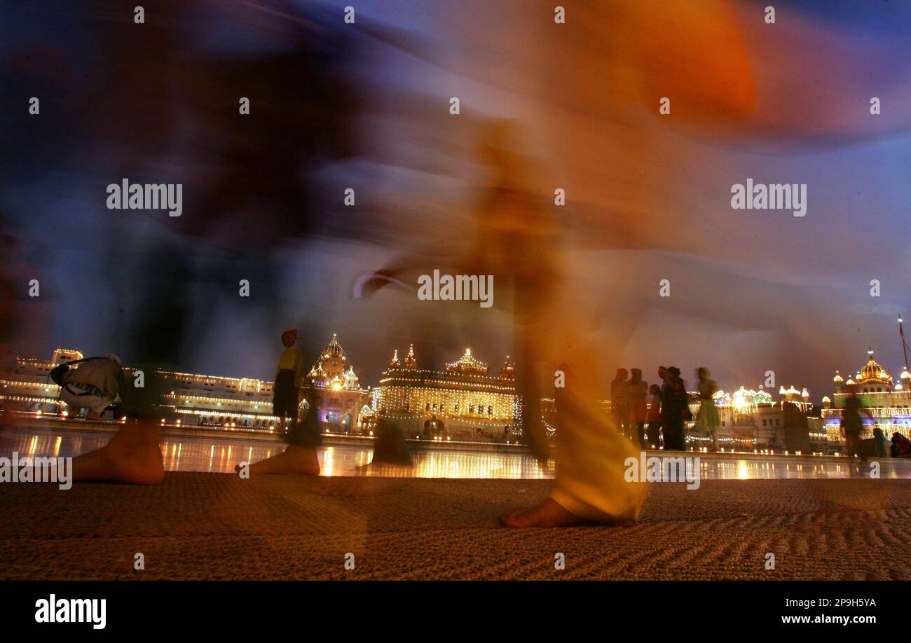 Sikh devotees walk past the Golden Temple, Sikh’s holiest shrine, on ...