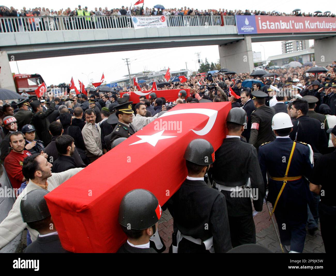 Soldiers carry the flag-draped coffins of Caglar Mengu and Oktay ...