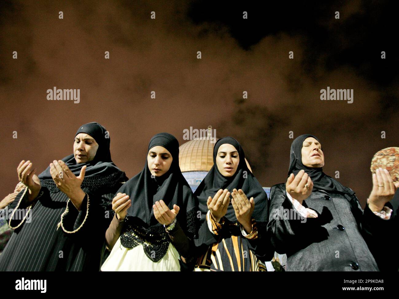 Female Palestinian Muslim worshipers pray during Lilat al-Qader, also ...