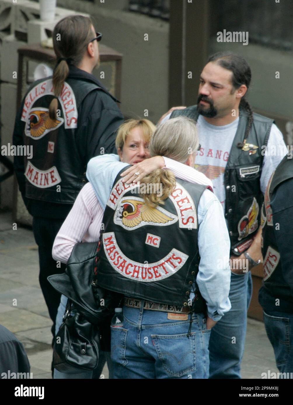 Hells Angels members embrace outside a funeral home during the memorial ...