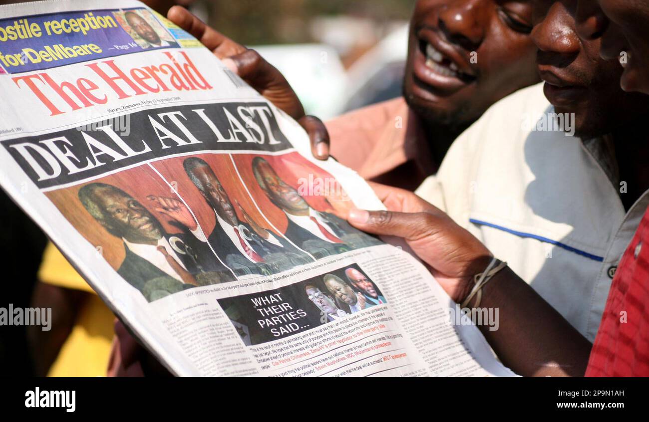 Zimbabweans read a newspaper in Harare Friday, Sept. 12, 2008. A ...