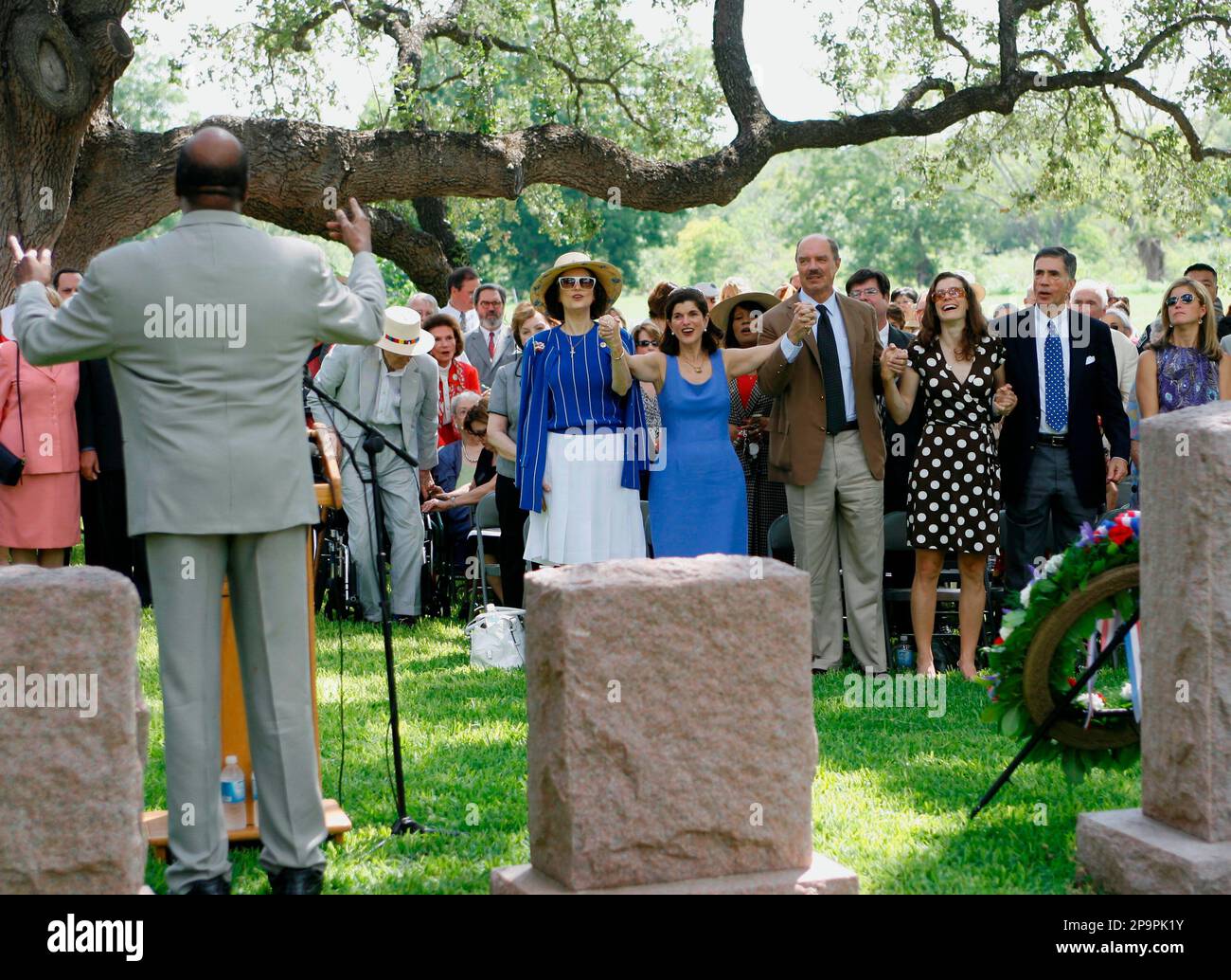 Soloist Johnny Ray Watson, left, leads relatives and friends of the ...