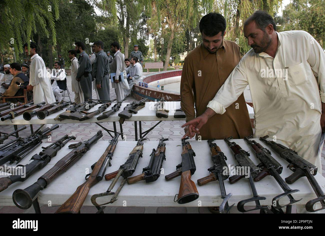 Afghans check the weapons during a ceremony of the arms and ammunitions ...