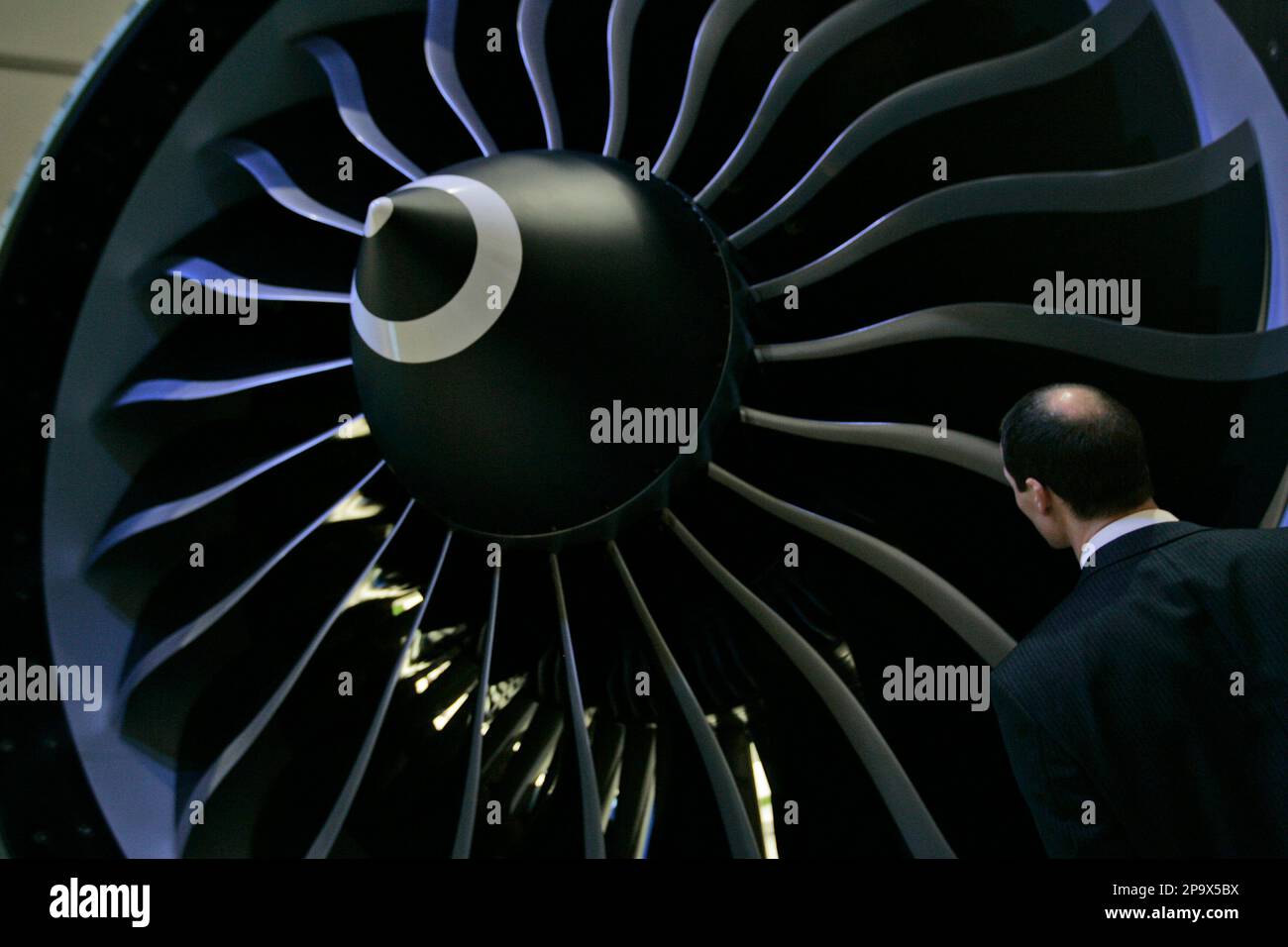 A visitor inspects a life-size model of the General Electric GE90-115B ...