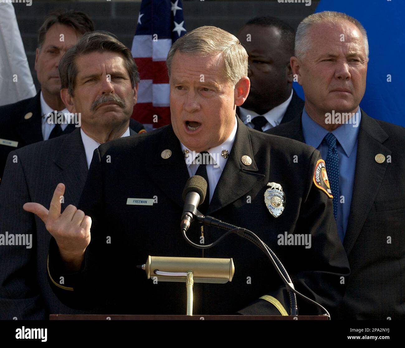 Los Angeles County Fire Chief Michael Freeman, center at podium ...
