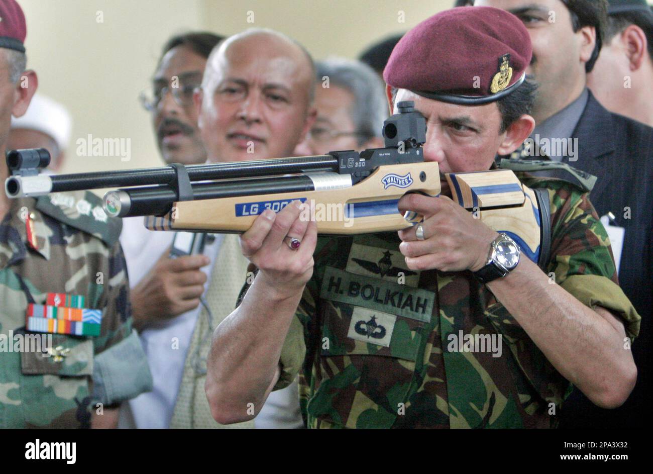 Brunei's Sultan Haji Hassanal Bolkiah tries his hand on an air gun ...