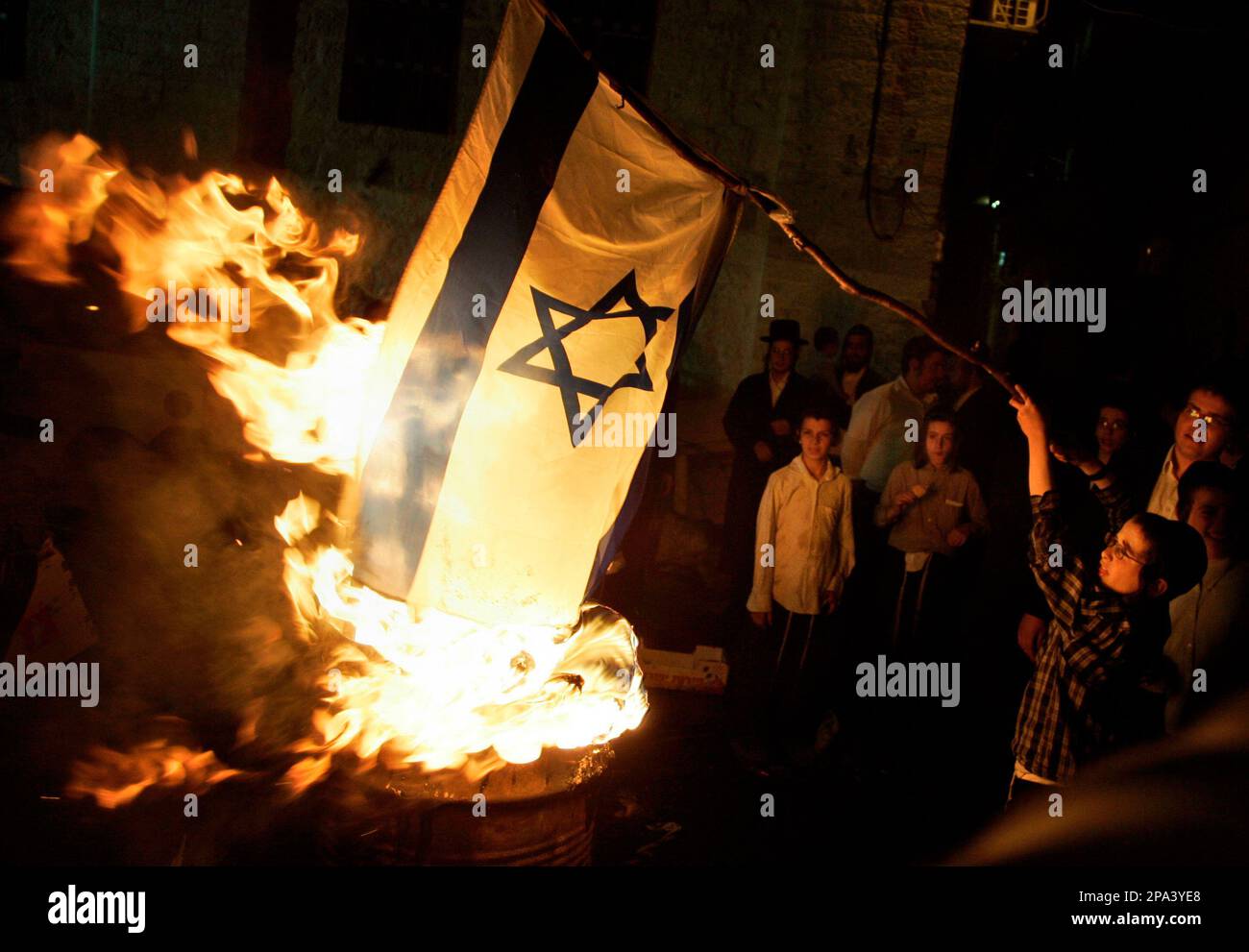 Ultra-Orthodox Jewish followers of the fringe group Neturei Karta burn ...