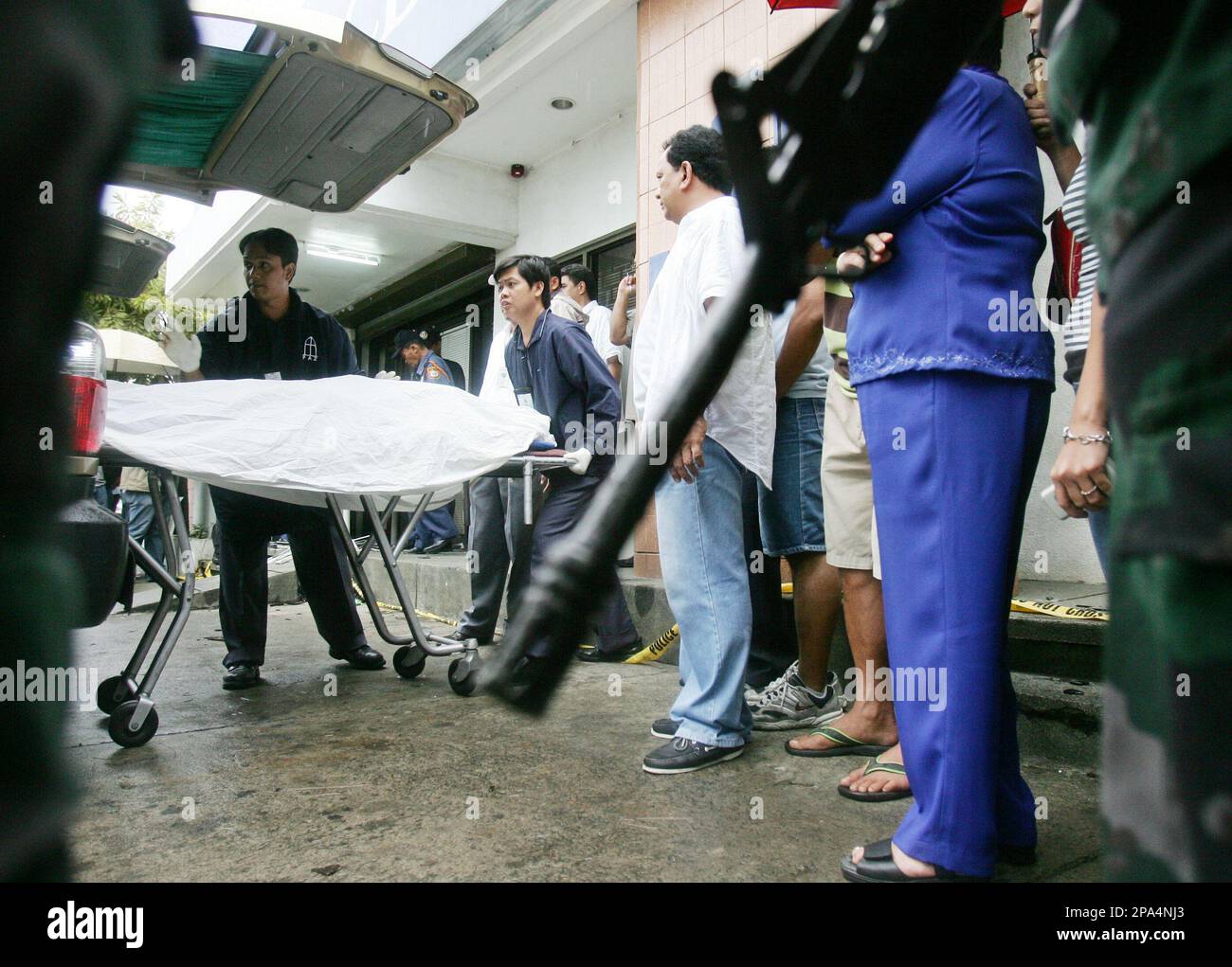 The body of one of nine victims is taken out of the RCBC Bank following ...