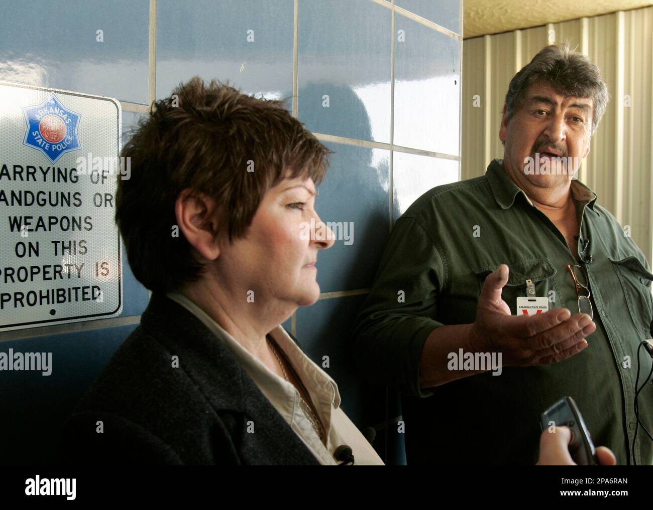 Mona Ward, left, listens as her husband Ron Ward speaks to reporters at ...