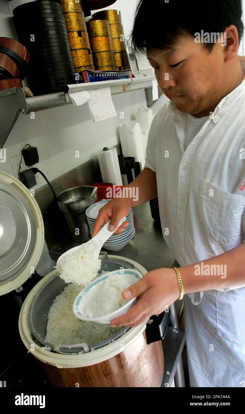 Frank Chu, manager of San Tung Chinese restaurant, scoops a bowl of ...