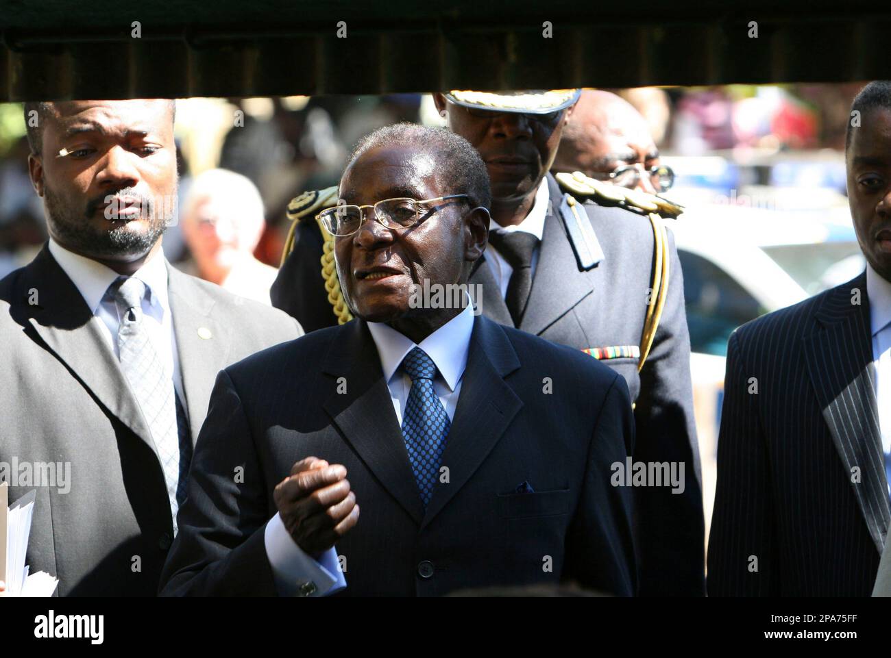 President Robert Mugabe, center, speaks during his tour of the Zimbabwe ...