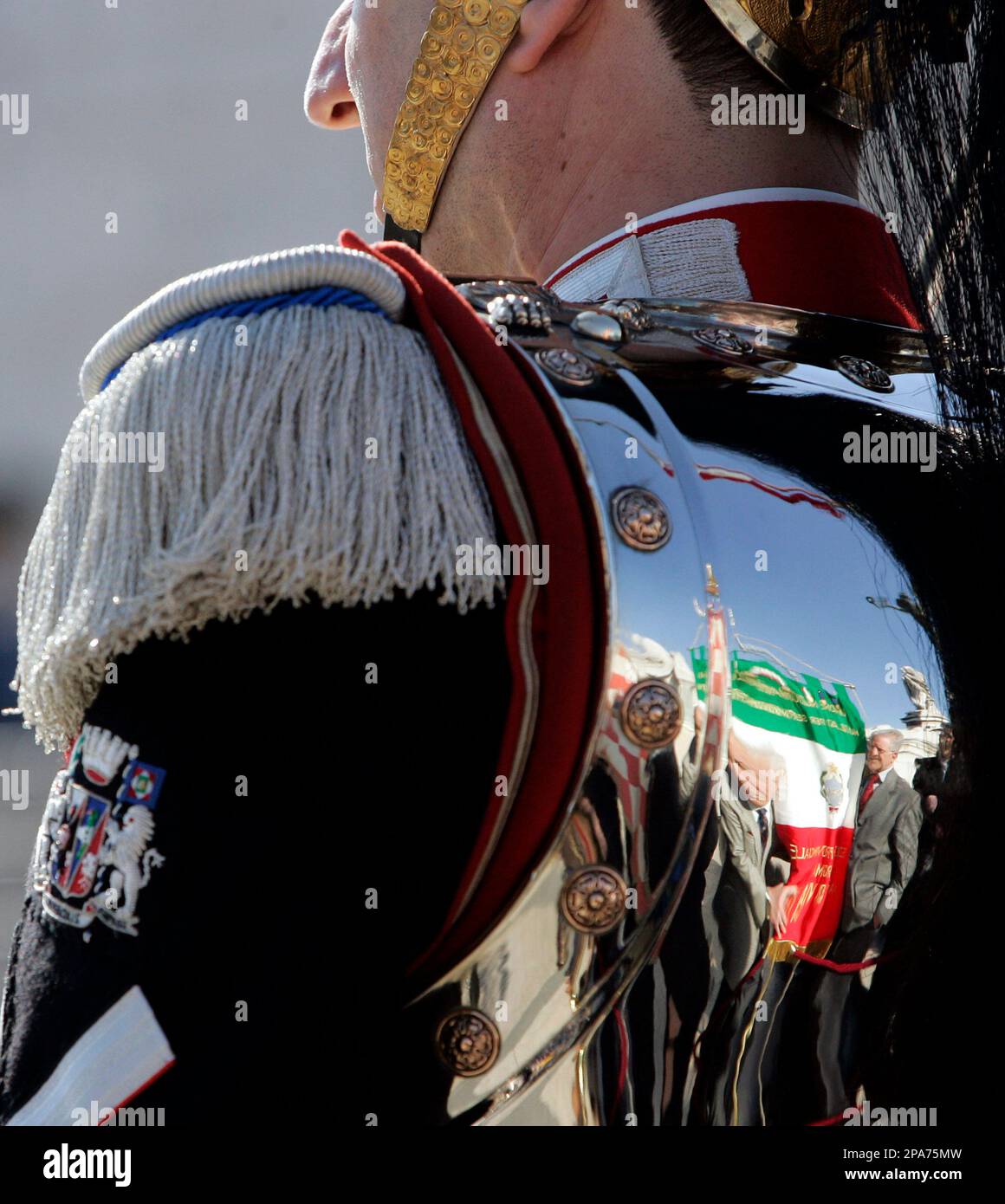 World War II veterans holding the Italian flag, are seen reflected in ...