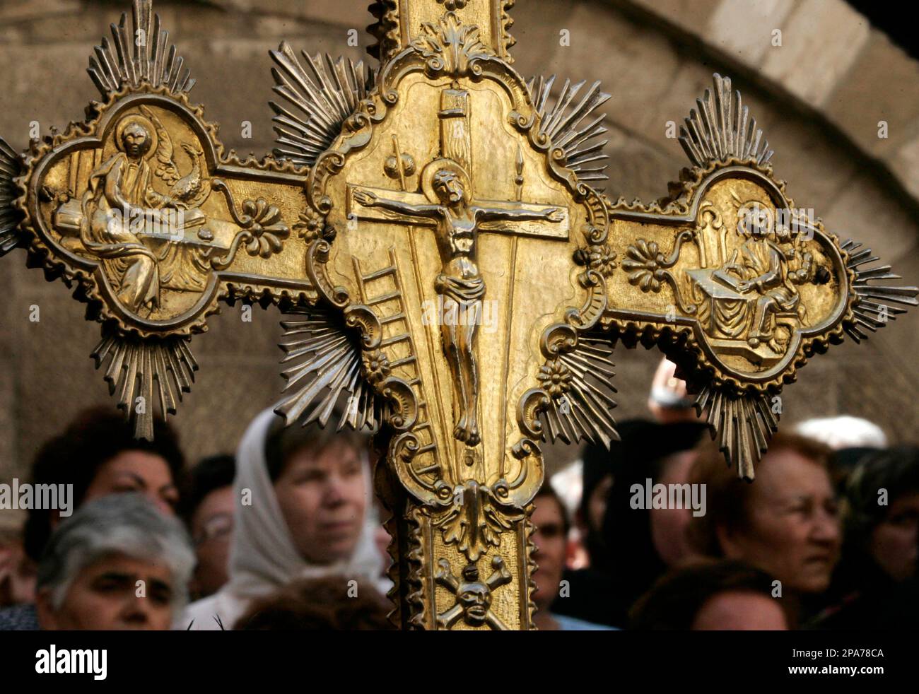 Orthodox Pilgrims stand behind a cross during the Washing of the Feet ...