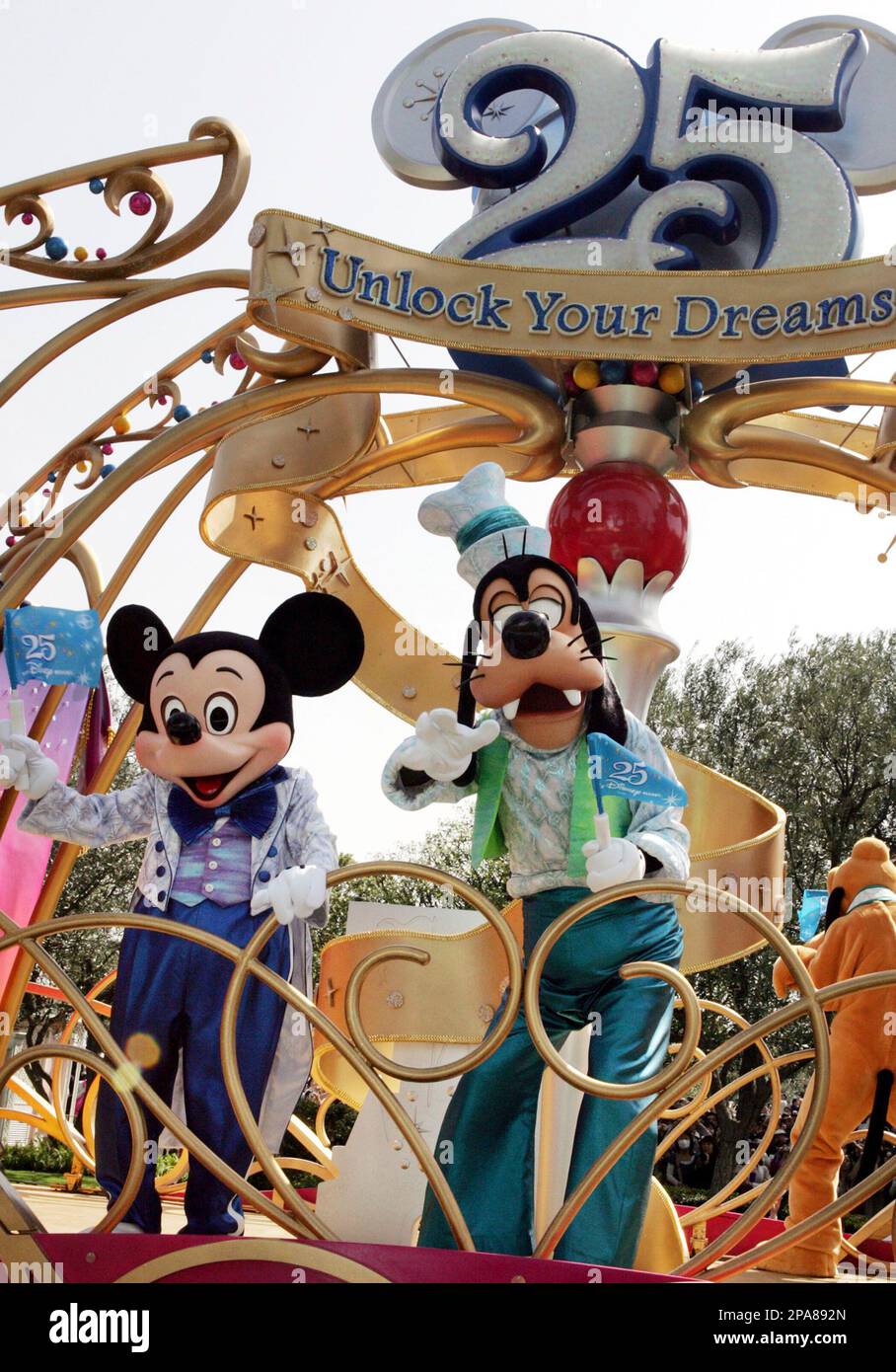 Mickey Mouse and Goofy perform during a parade to mark the 25th ...