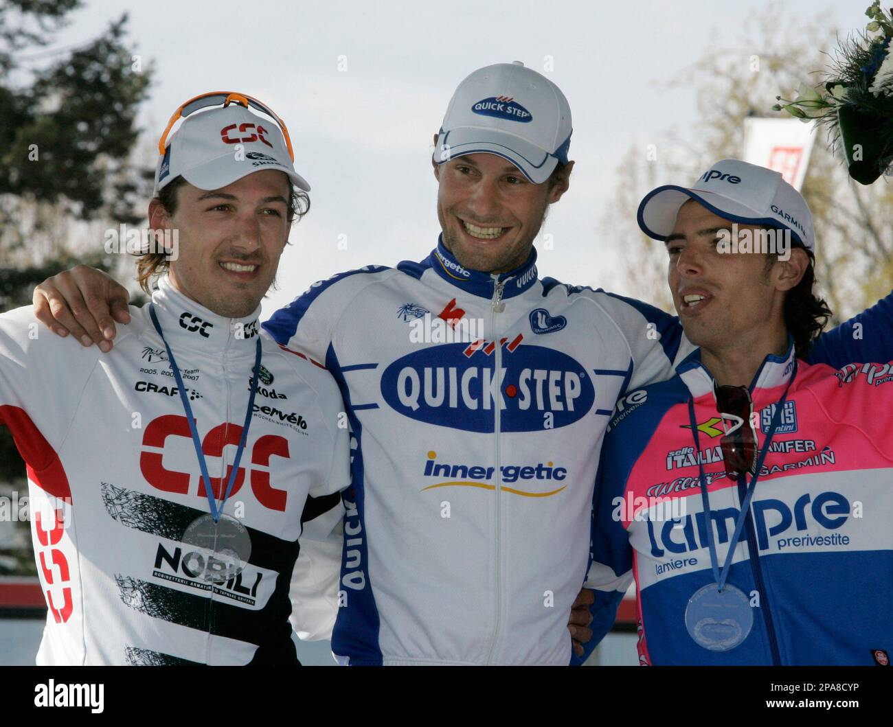 Belgium's Tom Boonen of the Quick Step team, center, poses with ...
