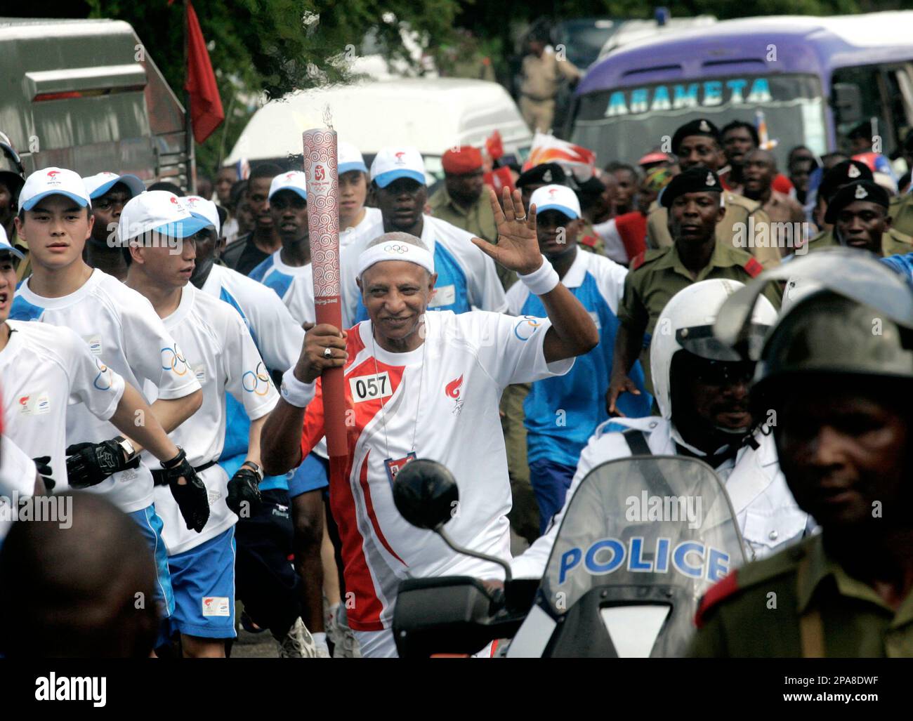 Under the protection of Tanzanian riot police, the Olympic torch is ...