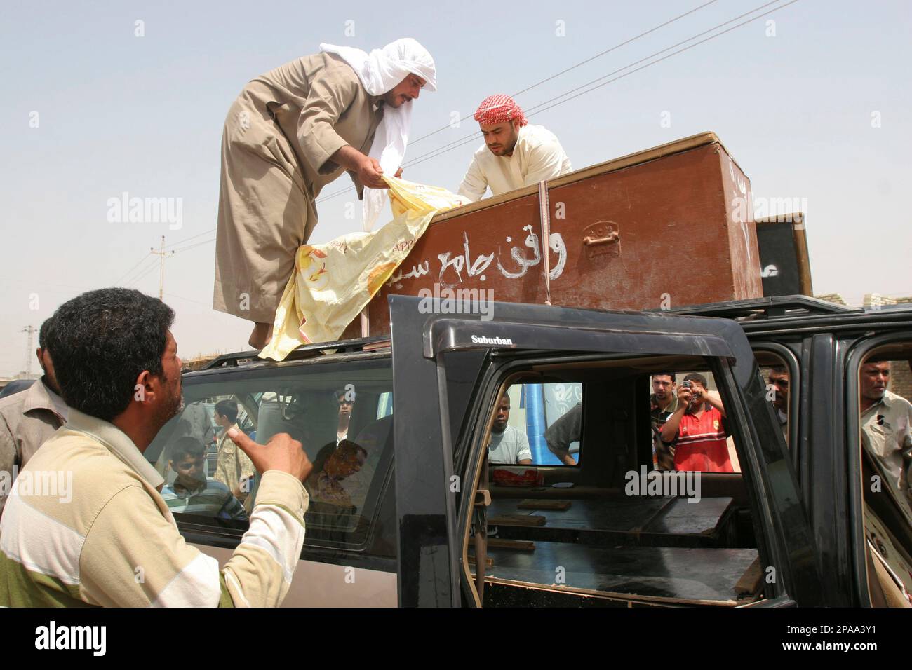 Relatives load the coffins of Mohammed Rijab, a primary school ...