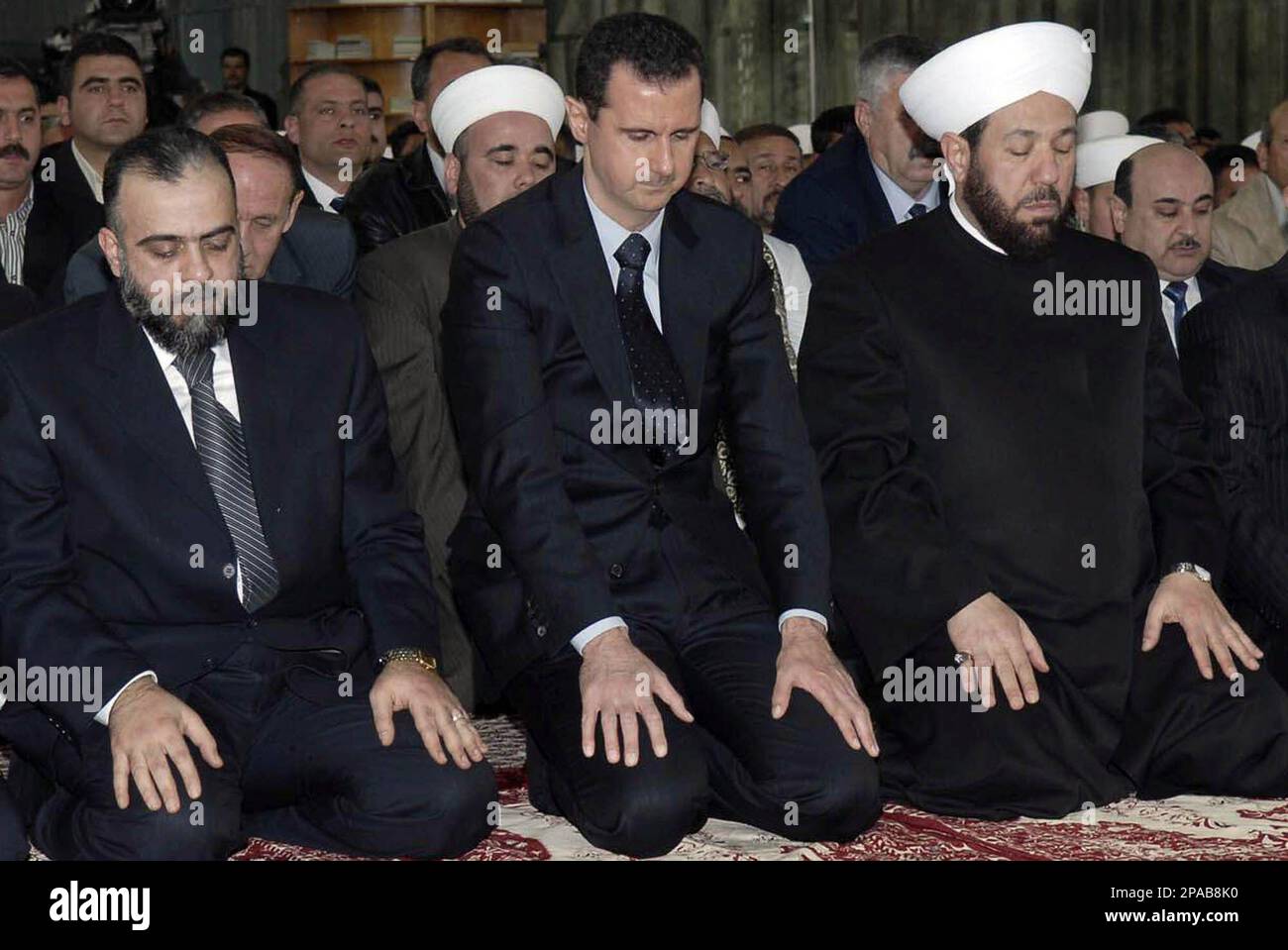 Syria's President Bashar Assad, centre, Syria's grand mufti Ahmad Badr ...