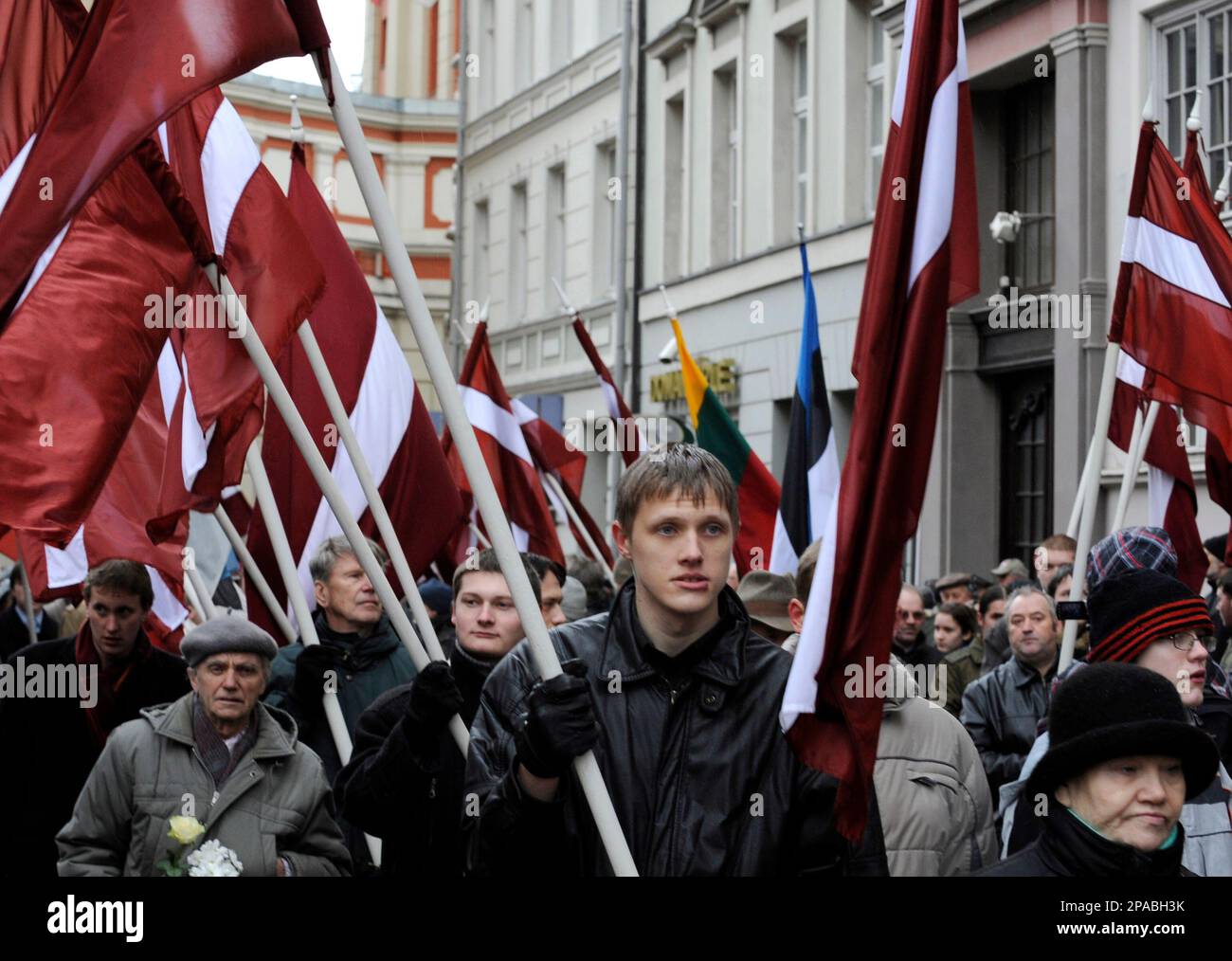 People carrying Latvian flags march to the Freedom Monument to honor ...