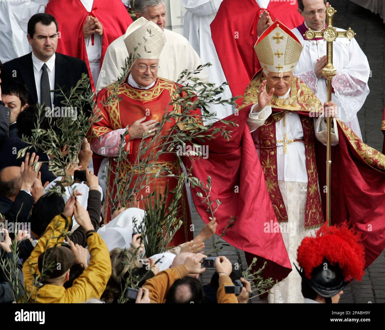 Pope Benedict XVI holds his papal staff as he walks in procession prior ...