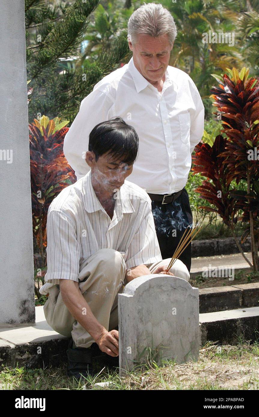 My Lai Massacre survivor Do Ba, 48, left, of Ho Chi Minh city, gives ...