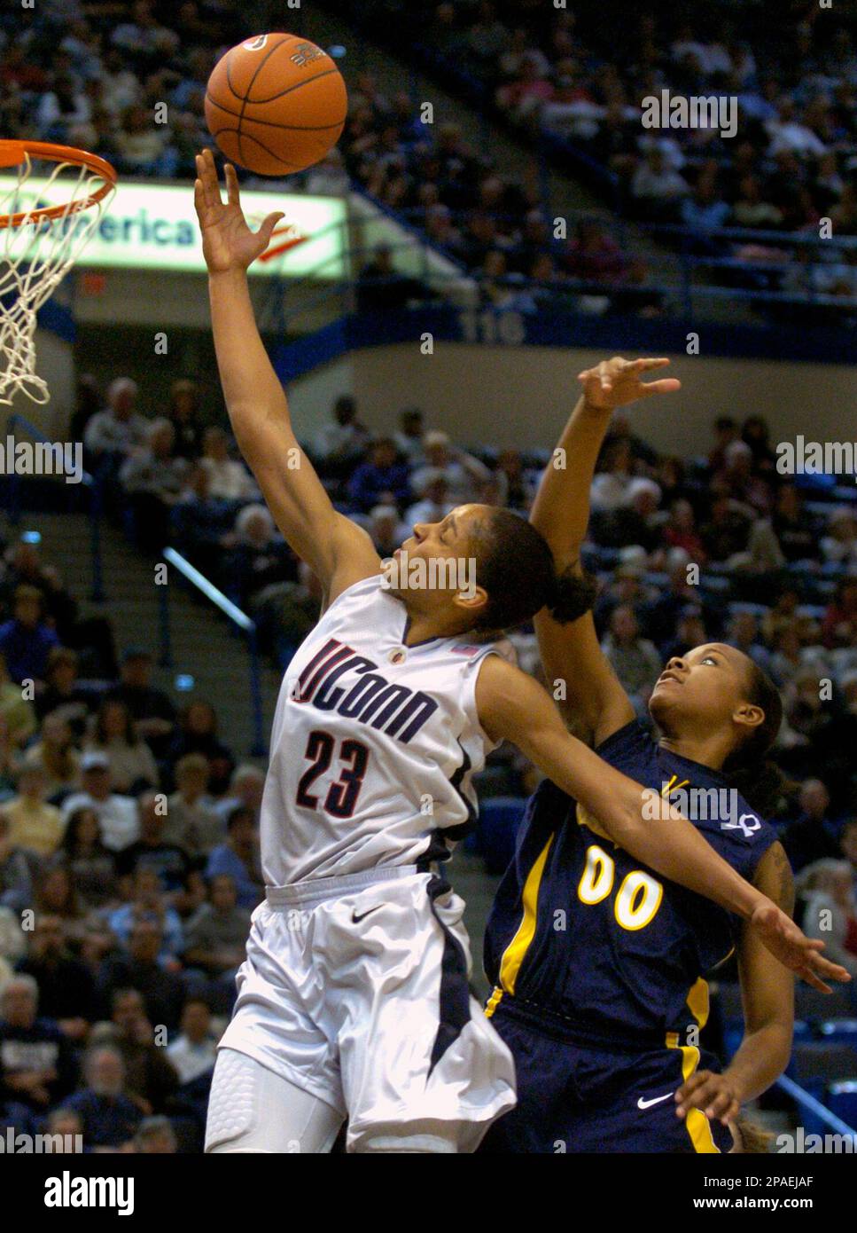 Connecticut's Maya Moore, left, is fouled as she drives to the basket ...