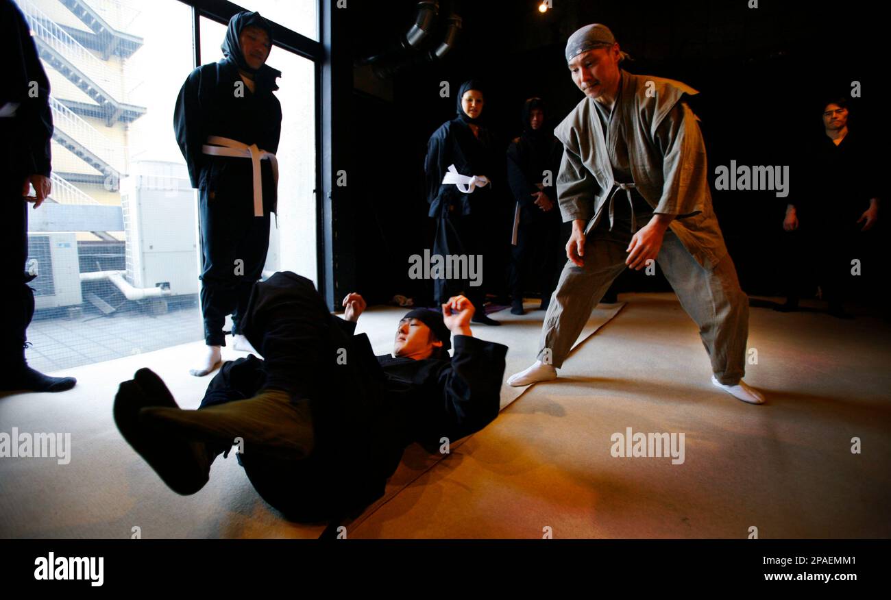 Foreign tourists stand and watch as Waki Masayuki, ninja master of ...