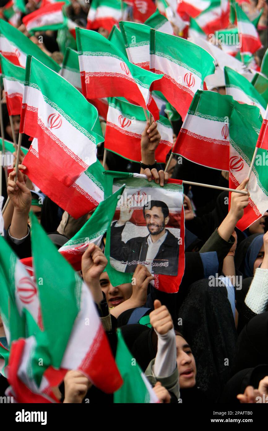 Iranian female students hold Iran's national flags and President ...