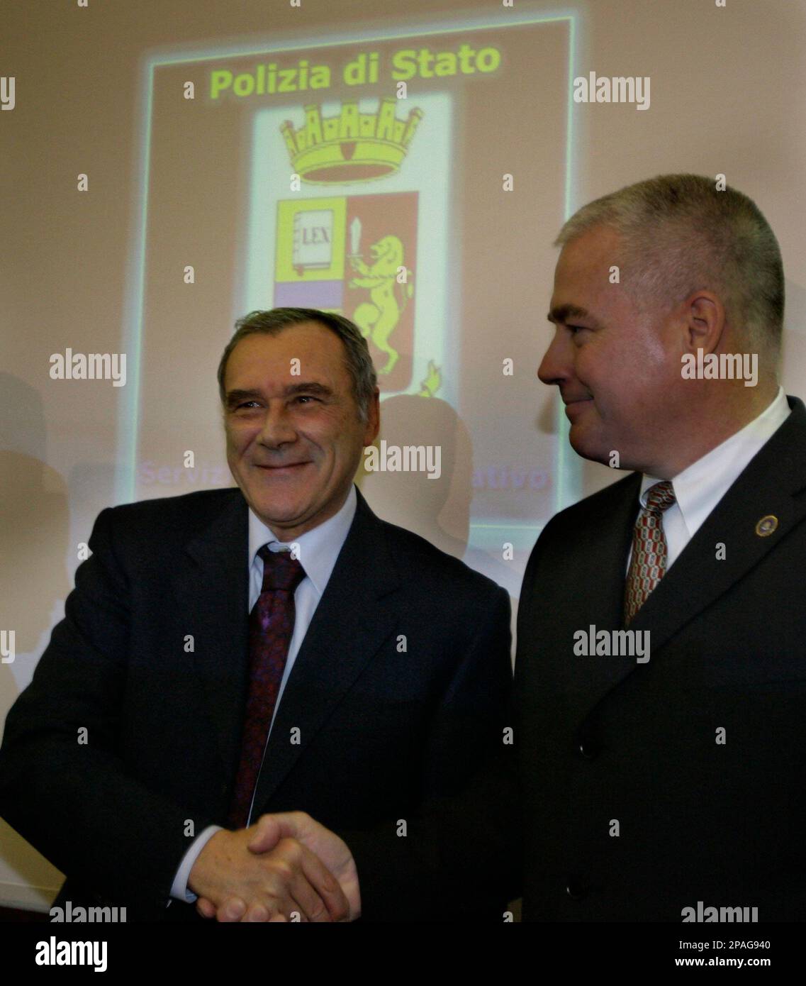 Italy's national anti-Mafia prosecutor Piero Grasso, left, shakes hands ...