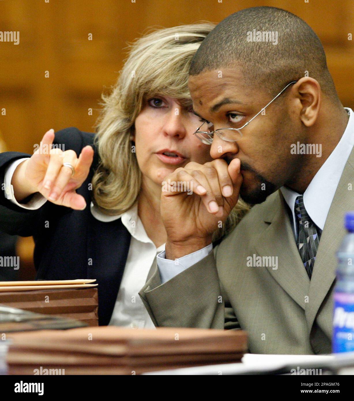 Former Canton patrolman Bobby Cutts Jr., left, talks with his attorney ...