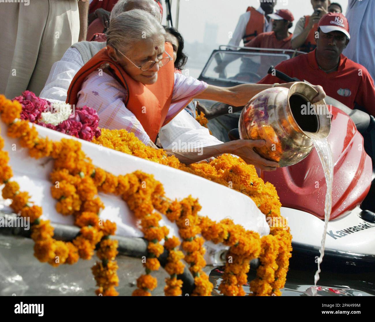 Mohandas K Gandhi's great-granddaughter Neelam Parikh pours an urn ...