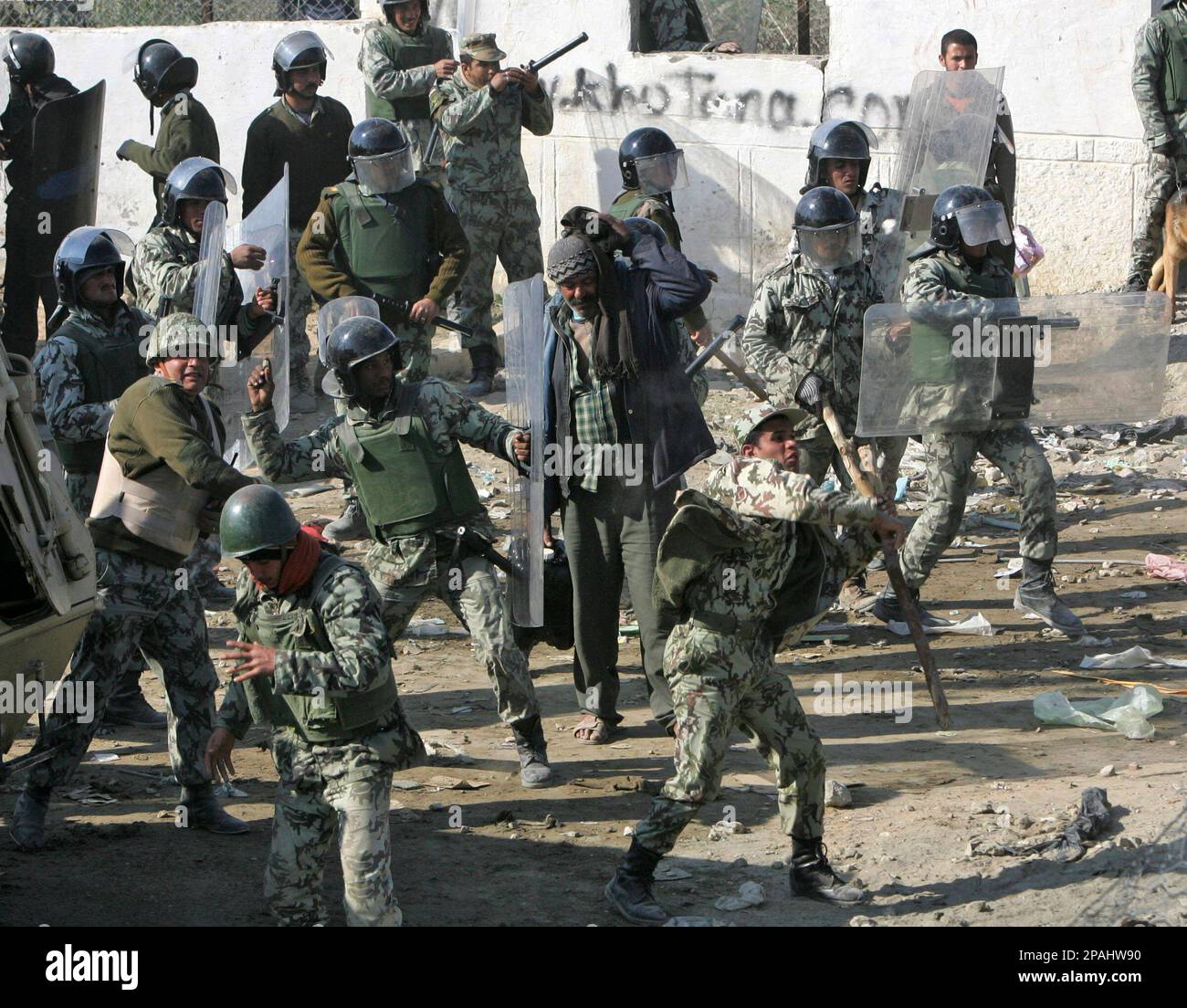 Egyptian border guards and riot police officers clash with Palestinians trying to cross the ...