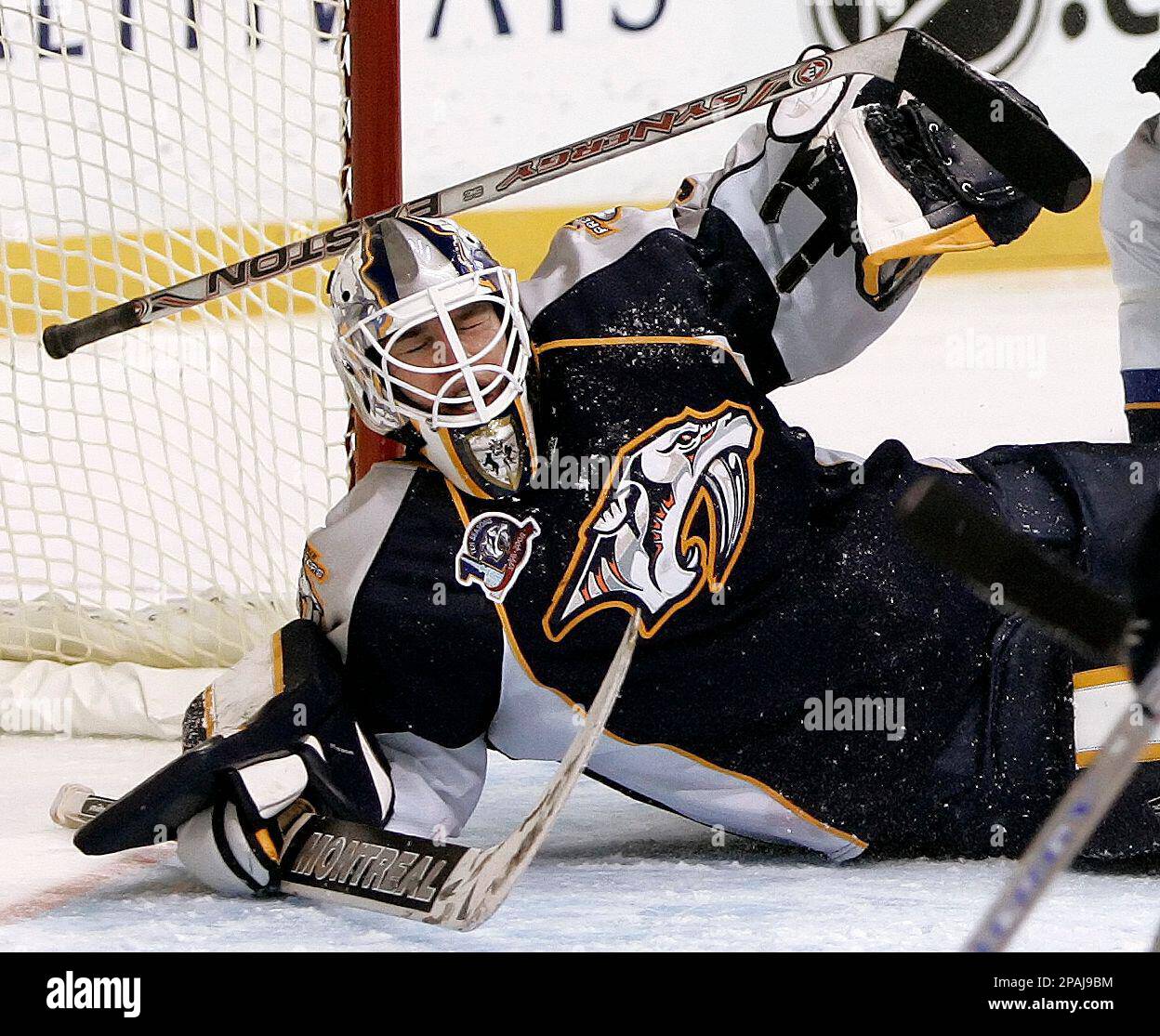 Nashville Predators goalie Chris Mason is hit in the head by a loose ...