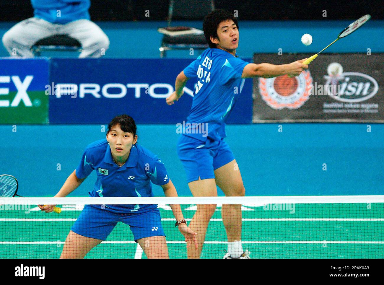 Lee Yong-dae of South Korea, back, returns a shot against Hsieh Yu-Hsin and Chien Yu-Chin of ...