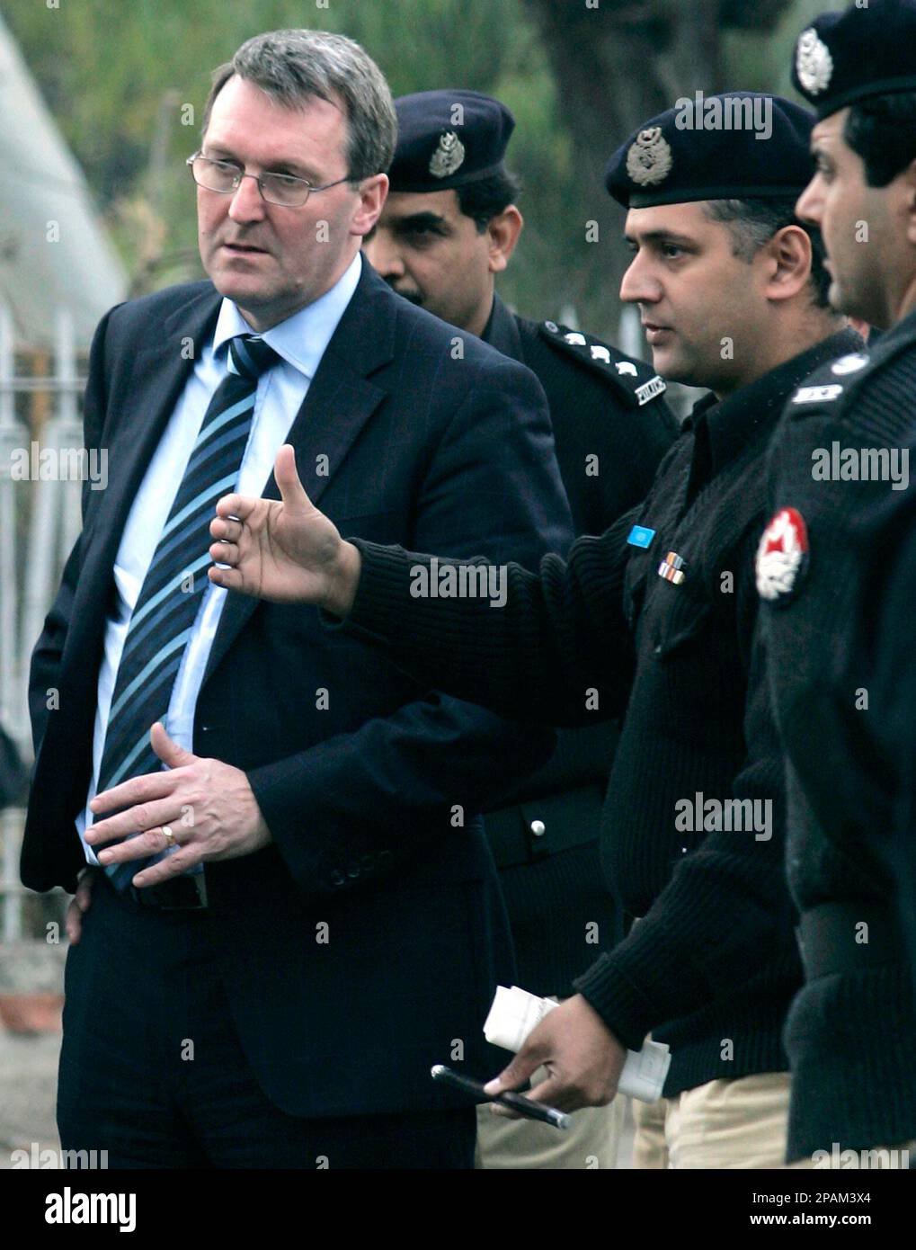 A Pakistani police officer briefs to a member of anti-terror team from ...