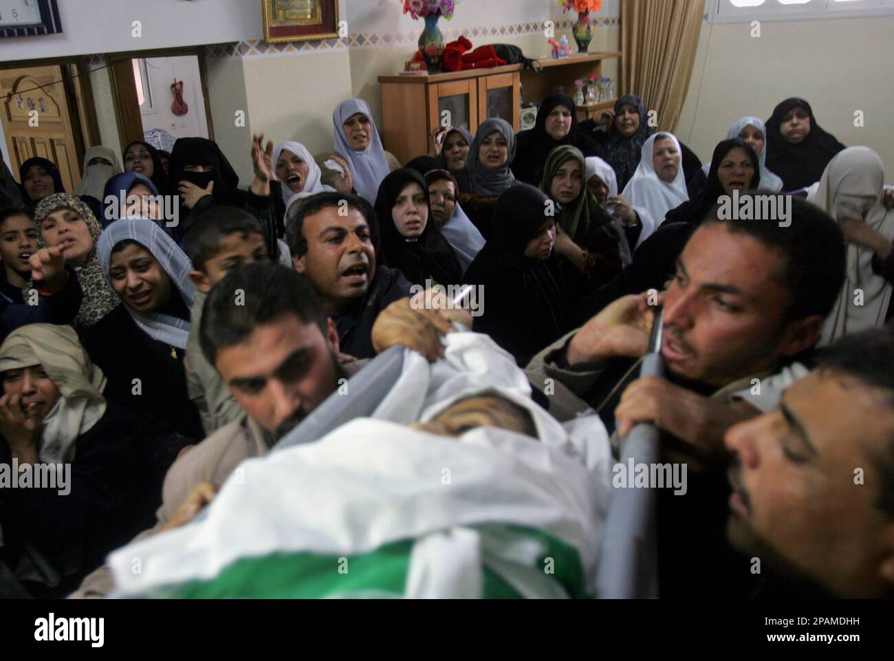 Palestinians carry the body of 14 year-old Mohammed Abu Al-Wafa during ...