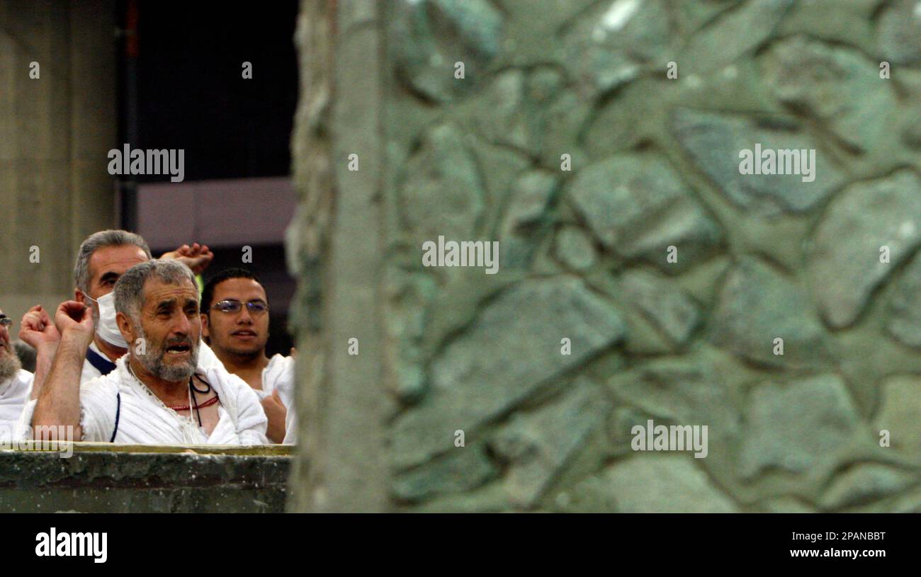Muslim Pilgrims perform the ritual "stoning of the devil" near the holy ...