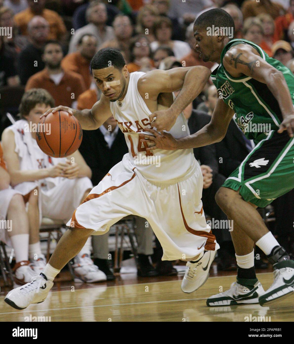 Texas guard D.J. Augustin, left, drives in front of North Texas' Collin ...