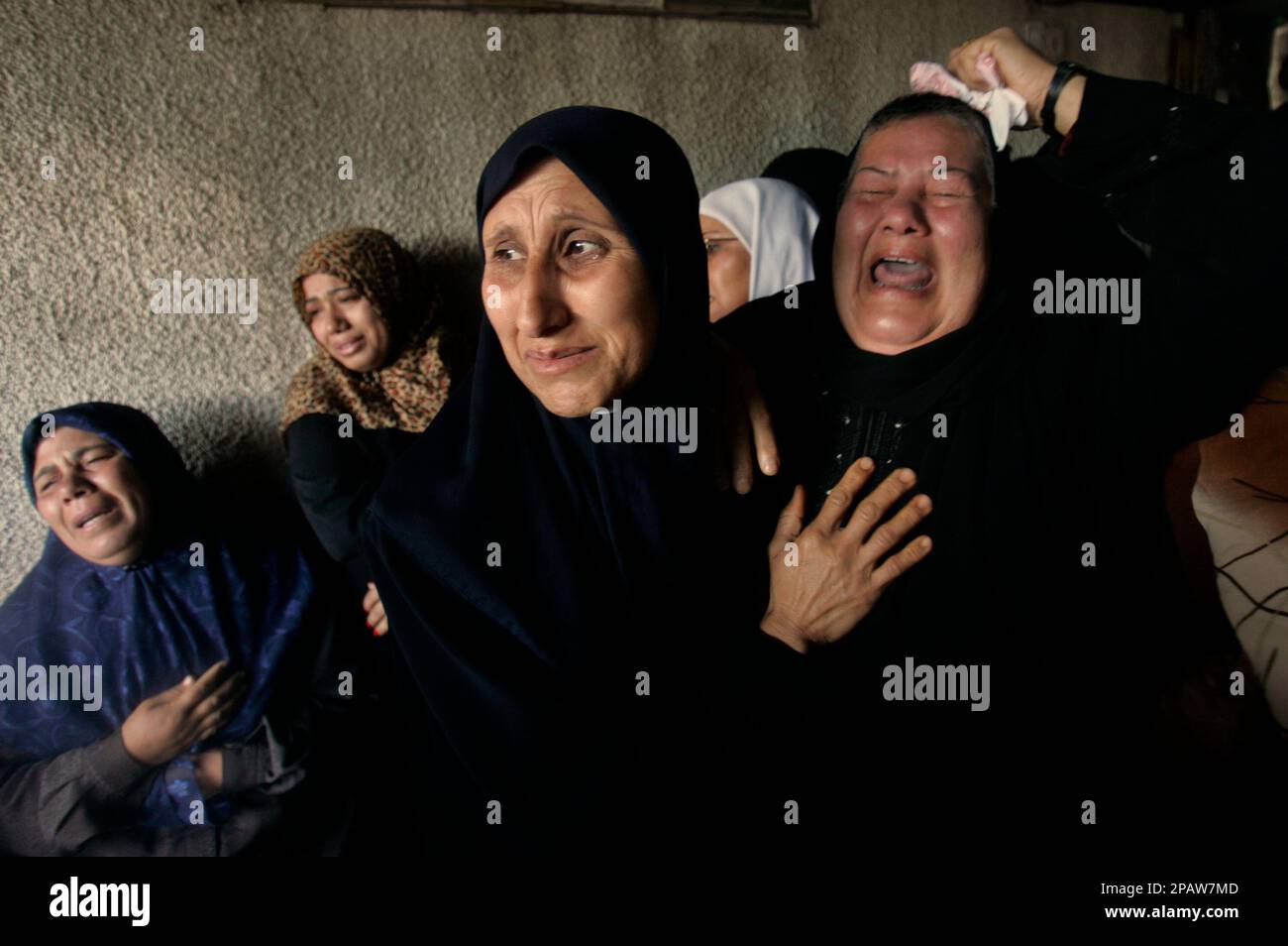 Palestinian relatives of Ibrahim Ahmed, 13, react during his funeral at ...