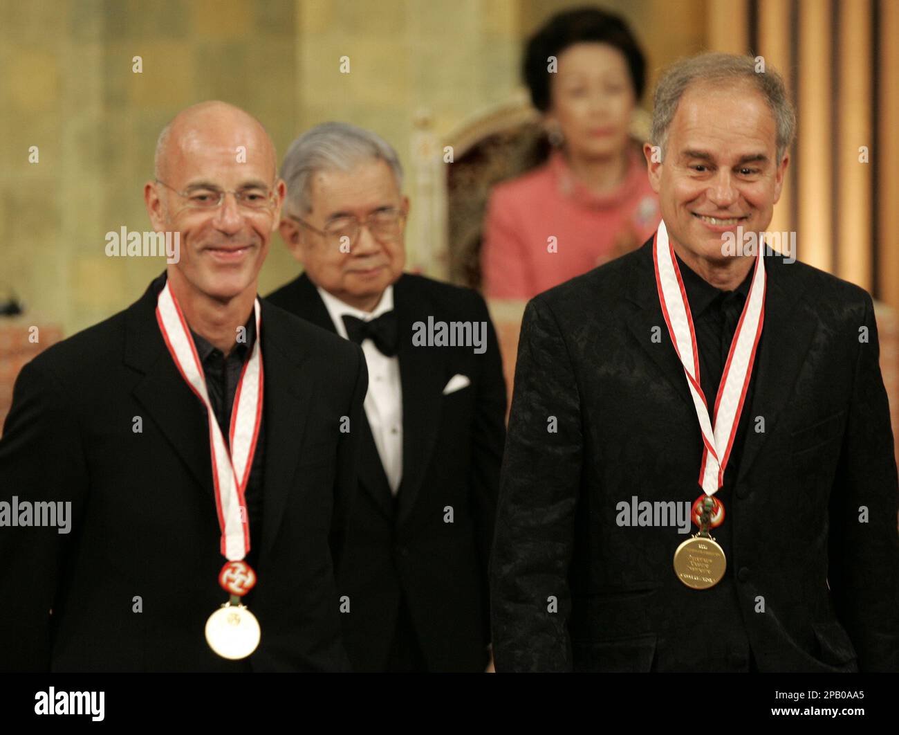 Swiss architects Jacques Herzog, left, and Pierre de Meuron, right, smile upon being conferred ...