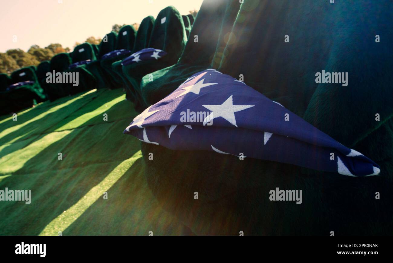 Flags are placed on chairs of next of kin prior to the start of a ...