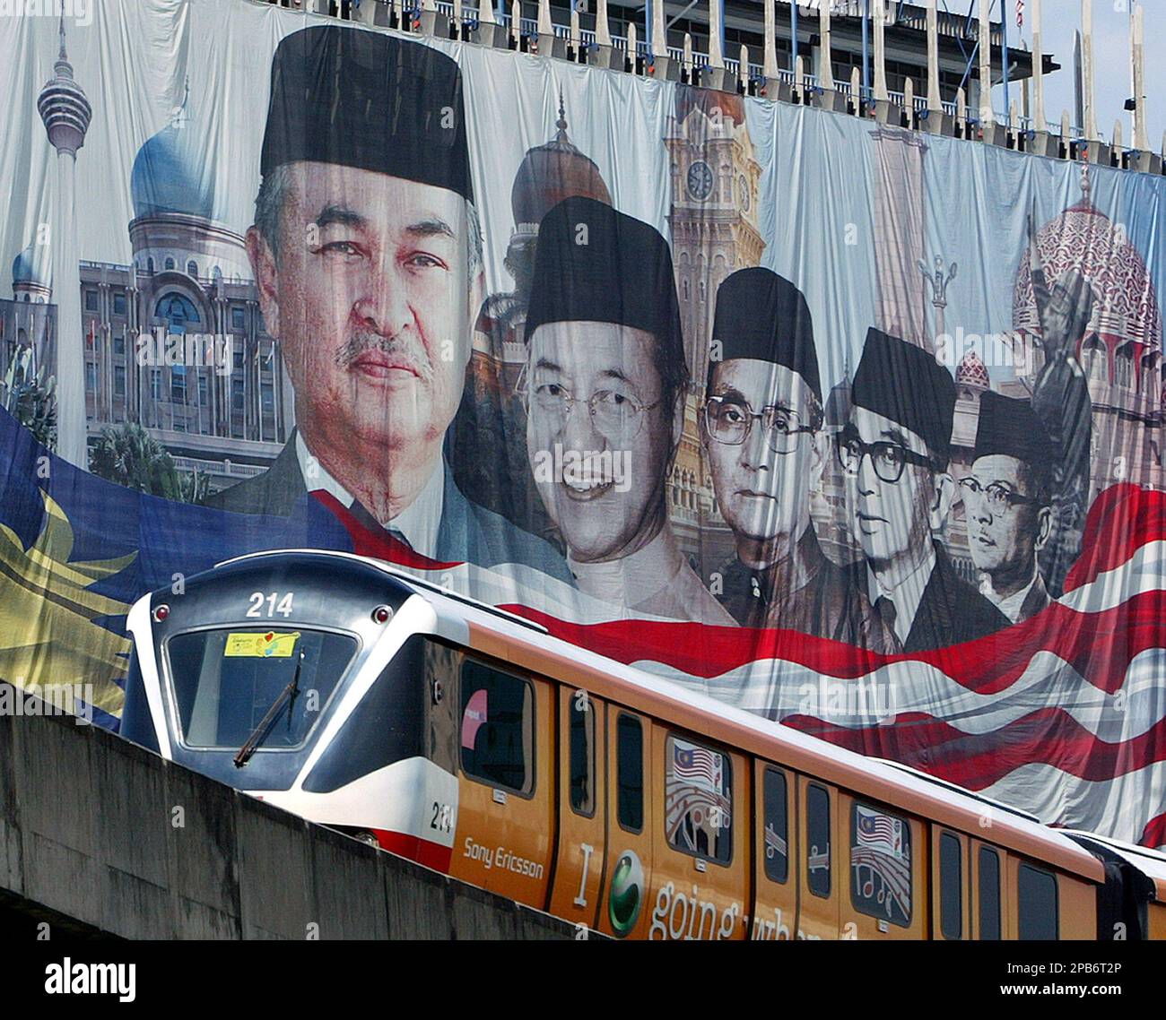 A Light Rail Transit (LRT) passenger train passes by a banner of the ...