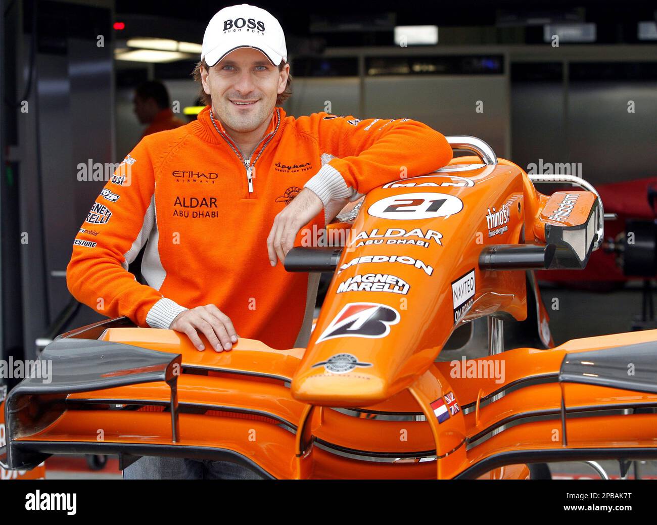 Germany's F1 driver Markus Winkelhock of the Spyker team poses behind parts of his race car at ...