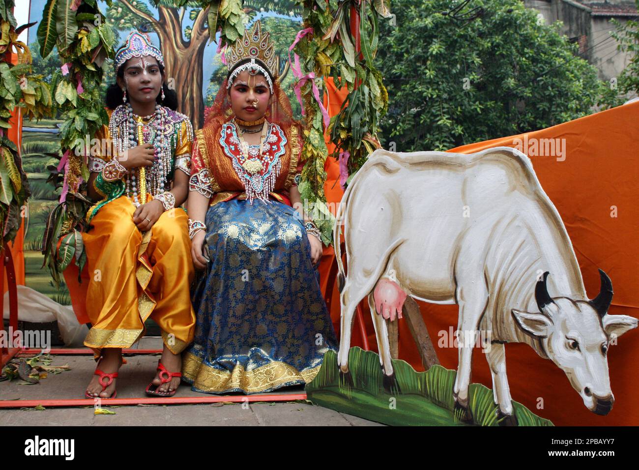 Children dressed as Hindu Gods Radha and Krishna, left, sit on a ...